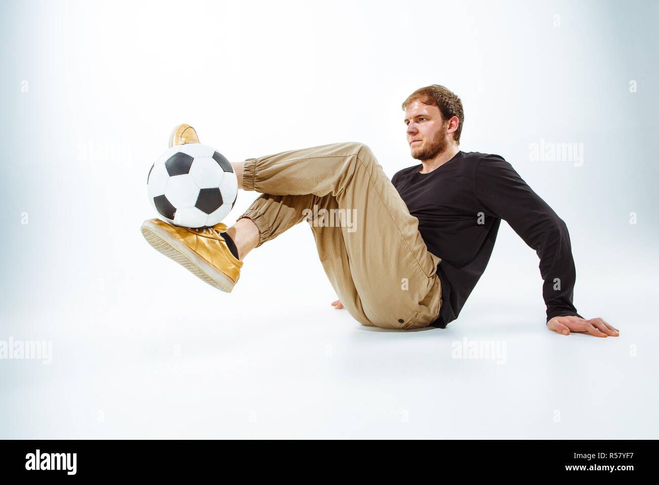 A portrait of a fan with ball on gray studio background. Freestile ...