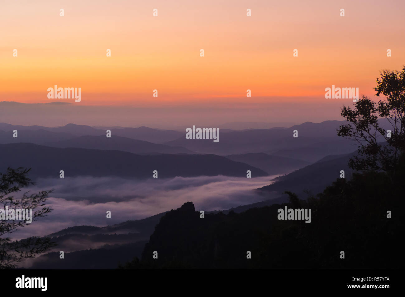 sunset overlooking mountains with Mist Stock Photo - Alamy