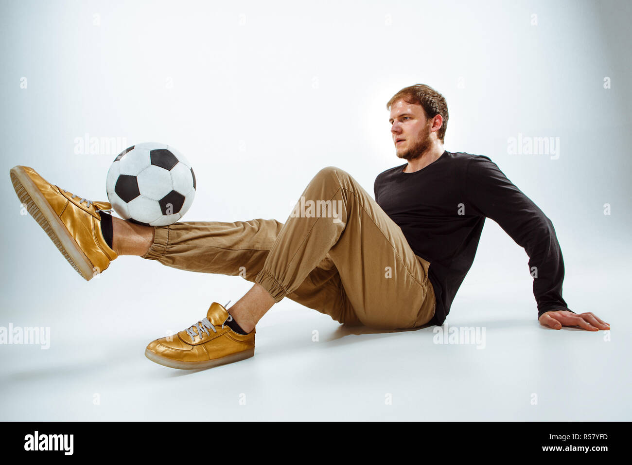 A portrait of a fan with ball on gray studio background. Freestile ...