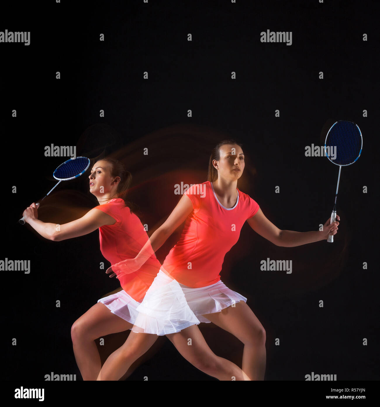 Young woman playing badminton over black background Stock Photo - Alamy