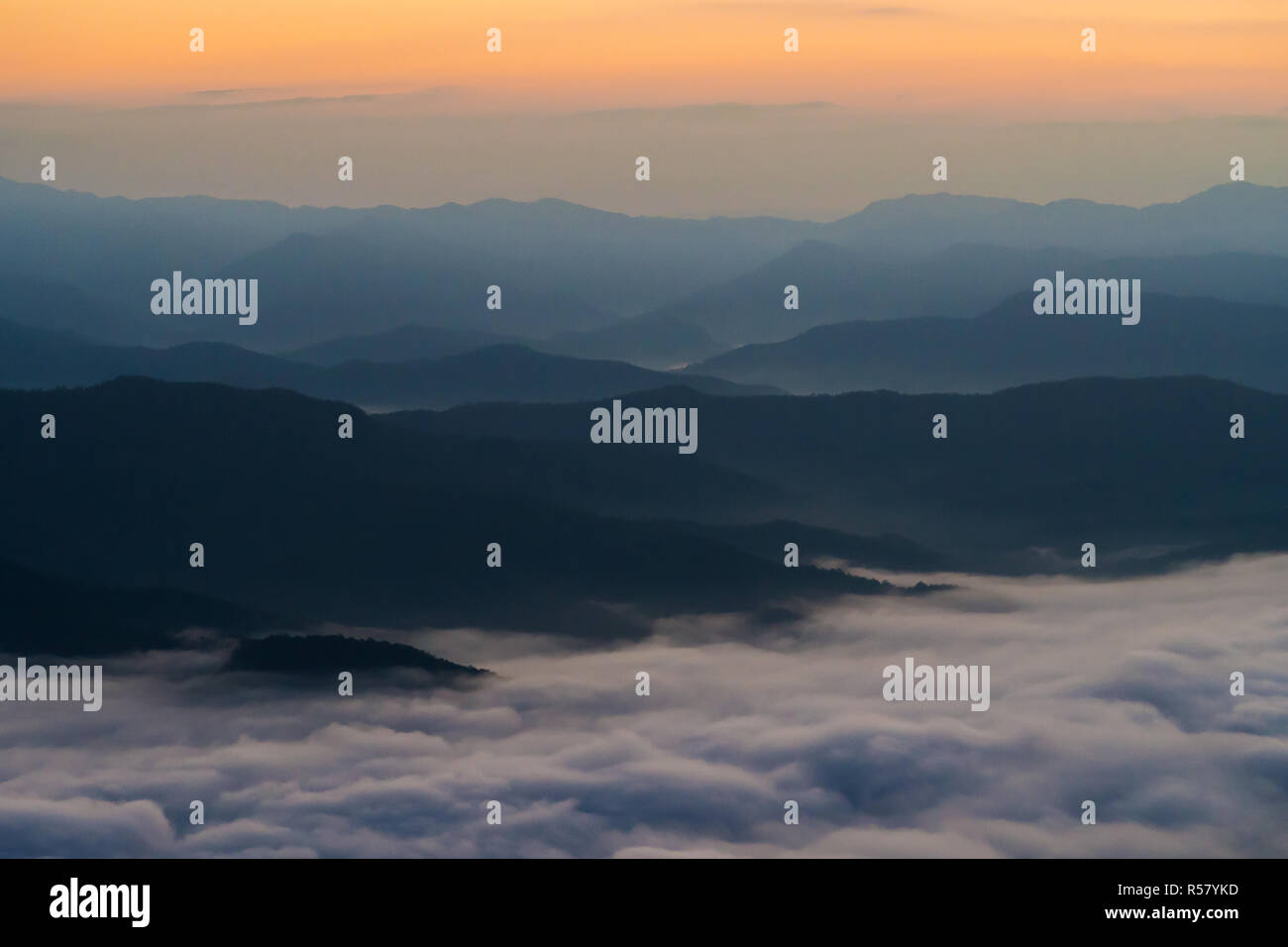 sunset overlooking mountains with Mist Stock Photo - Alamy