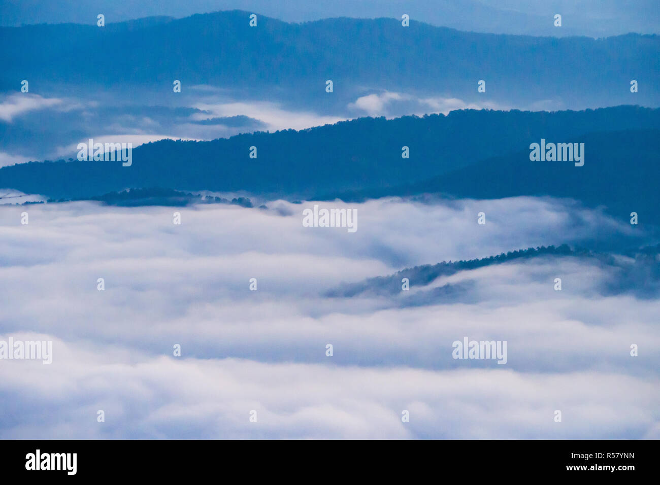 sunset overlooking mountains with Mist Stock Photo - Alamy