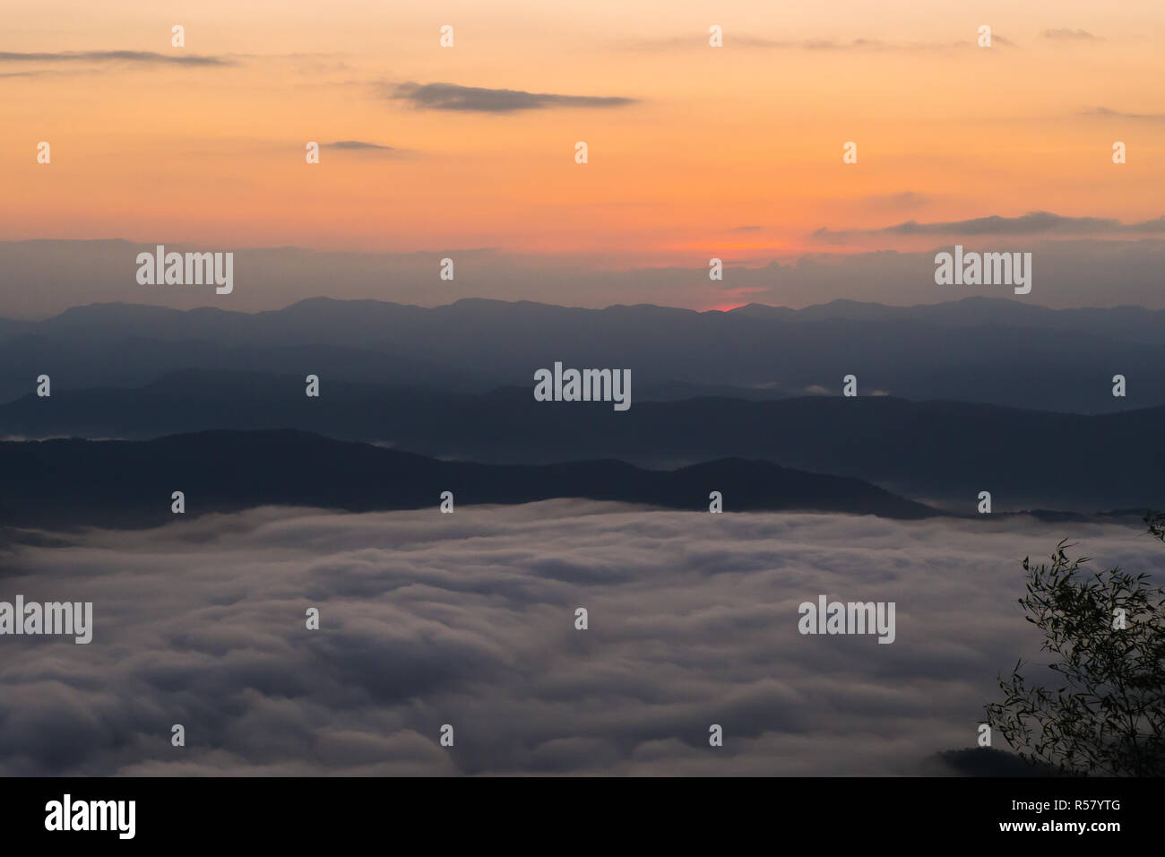 sunset overlooking mountains with Mist Stock Photo - Alamy
