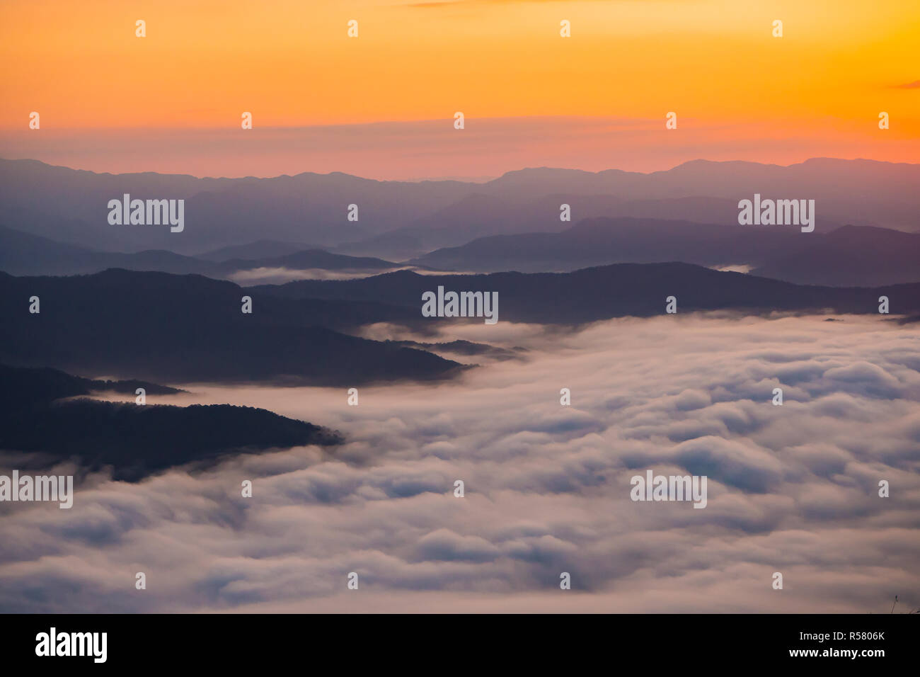 sunset overlooking mountains with Mist Stock Photo - Alamy