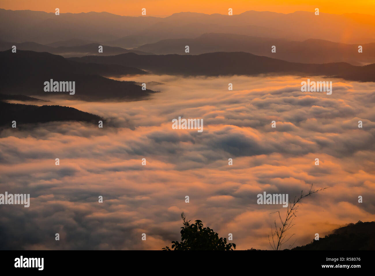 sunset overlooking mountains with Mist Stock Photo - Alamy