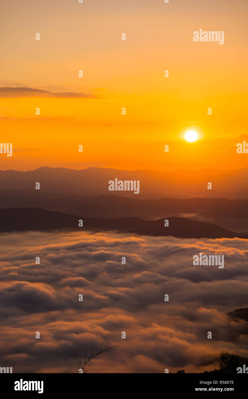 sunset overlooking mountains with Mist Stock Photo - Alamy