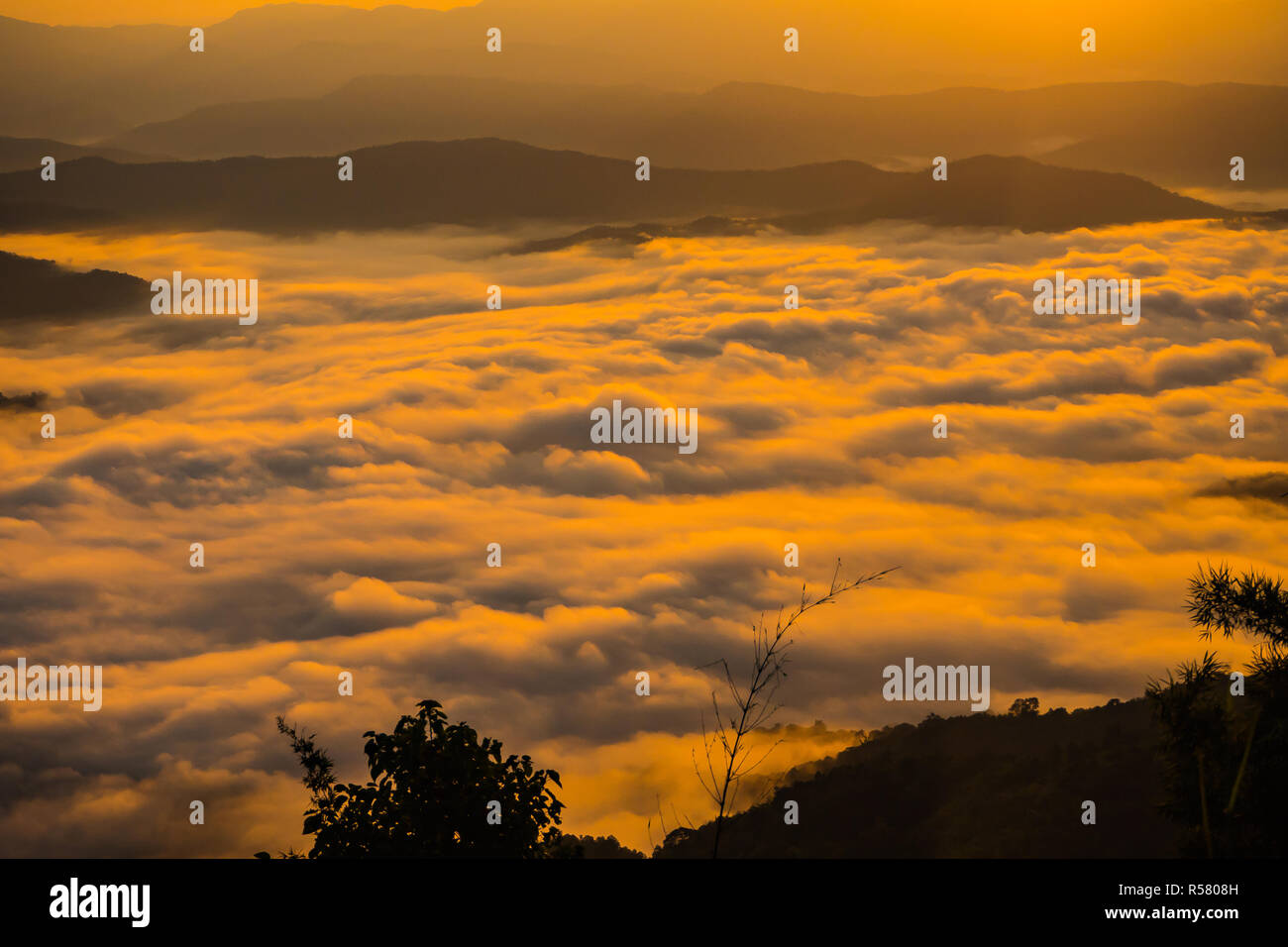 sunset overlooking mountains with Mist Stock Photo - Alamy