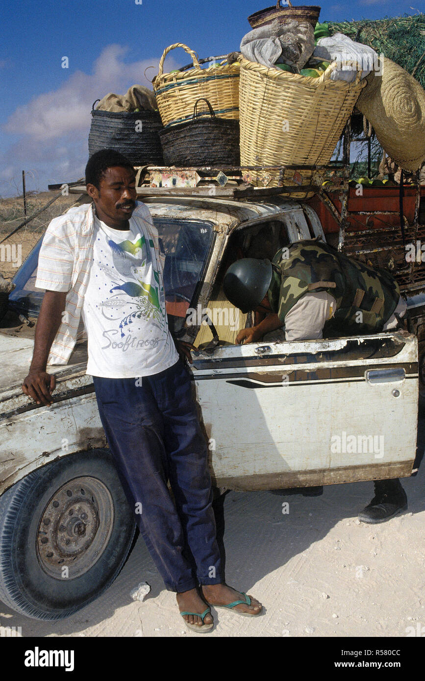 1993 - A Somali citizen leans casually ag ainst his vehicle as it is ...