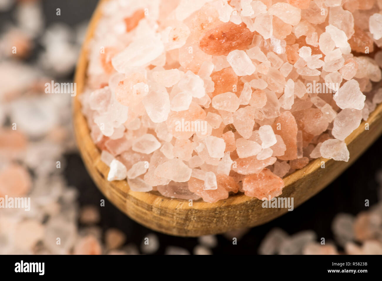 Himalayan pink crystal salt. spoon of pink himalayan salt on slate ...