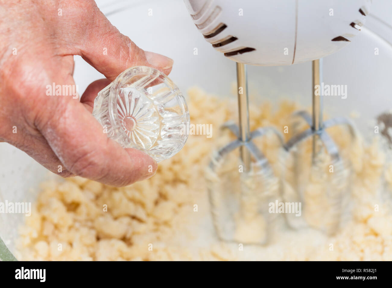 Adding vanilla flavouring essence Stock Photo - Alamy