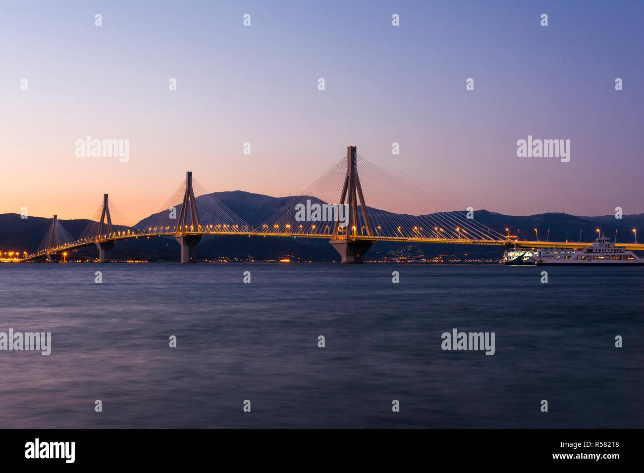 View of Rio-Antirio bridge at dusk, Greece. The Rio Antirrio Bridge is ...