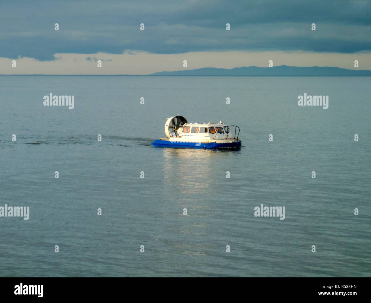 A small service ship in a cargo industrial port. A ship in the sea ...