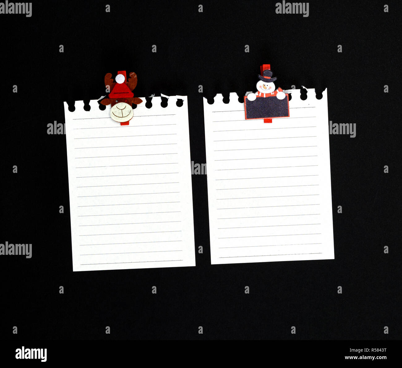 two white blank sheet in a line torn out of notepad on a back ...