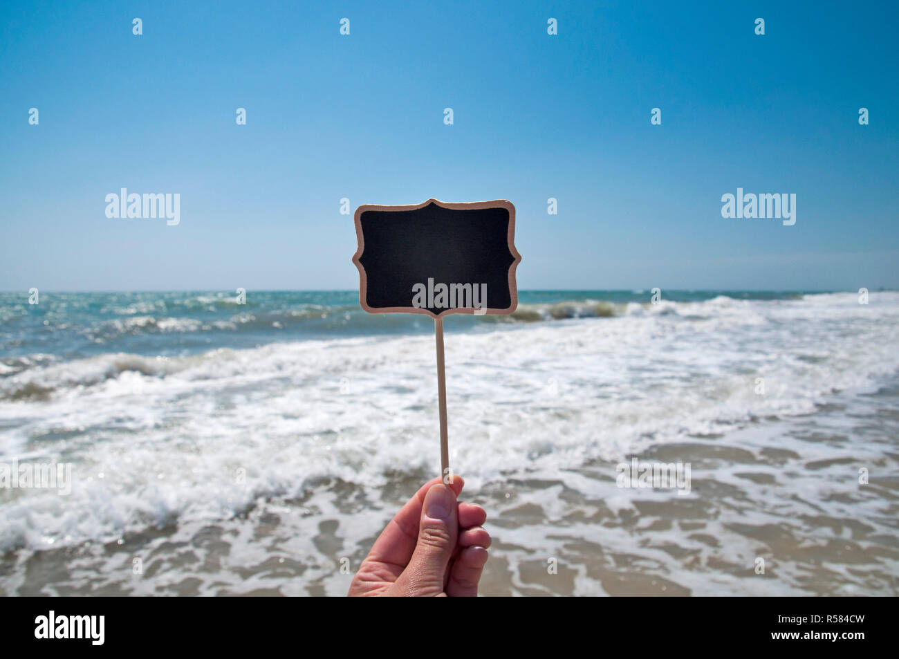 Empty wooden plaque in hand Stock Photo - Alamy