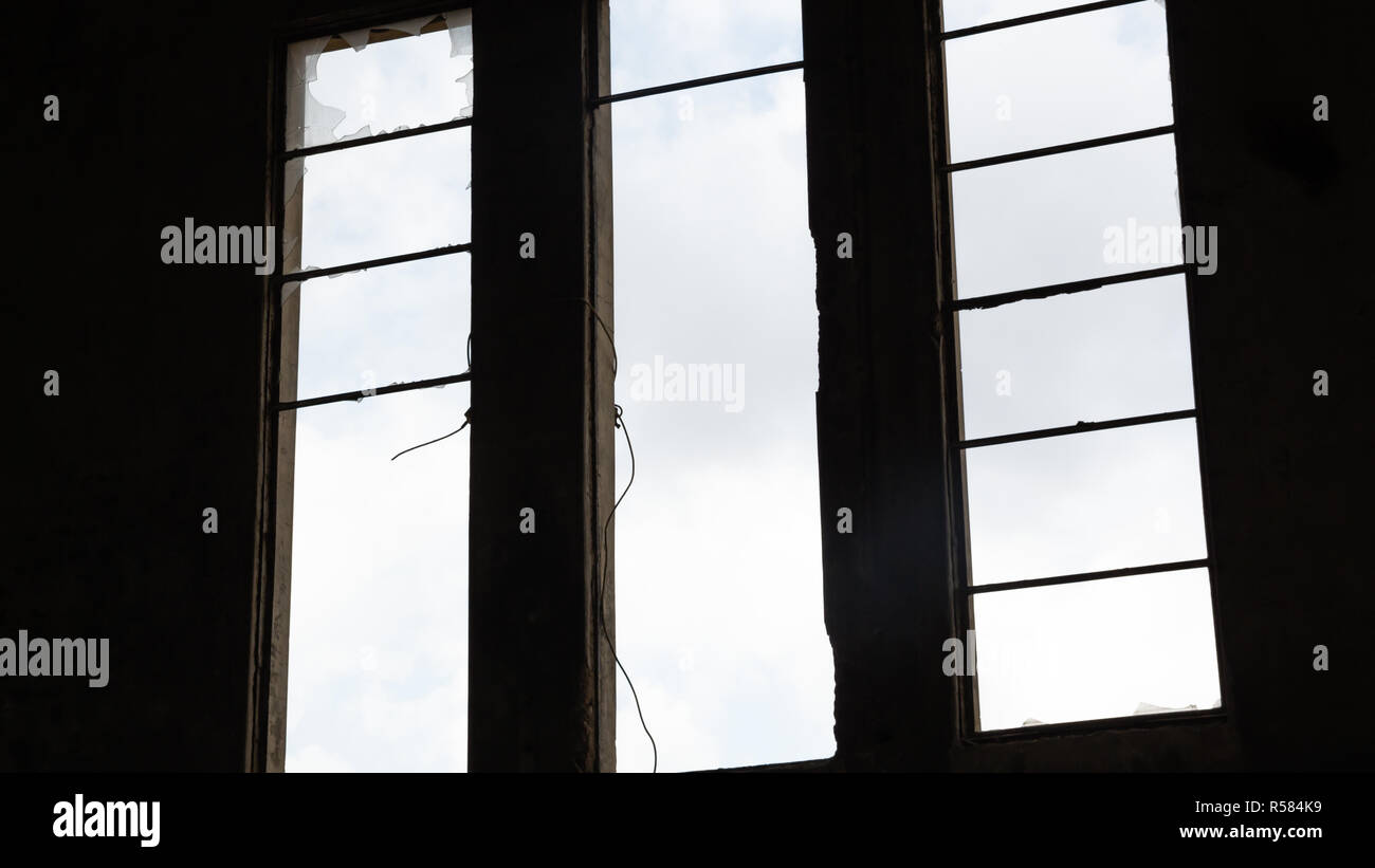 Broken window in an abandoned building Stock Photo - Alamy
