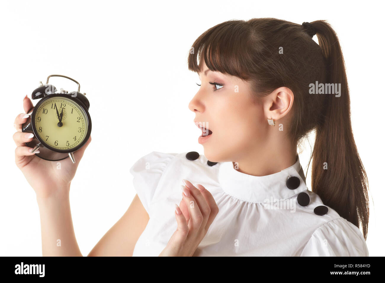 Young woman with alarm clock Stock Photo - Alamy