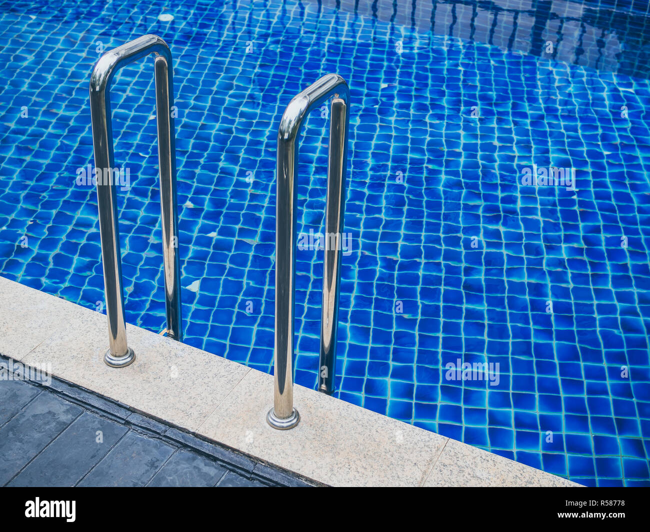 Grab bars ladder in swimming pool. Swimming pool stairs with copy space ...