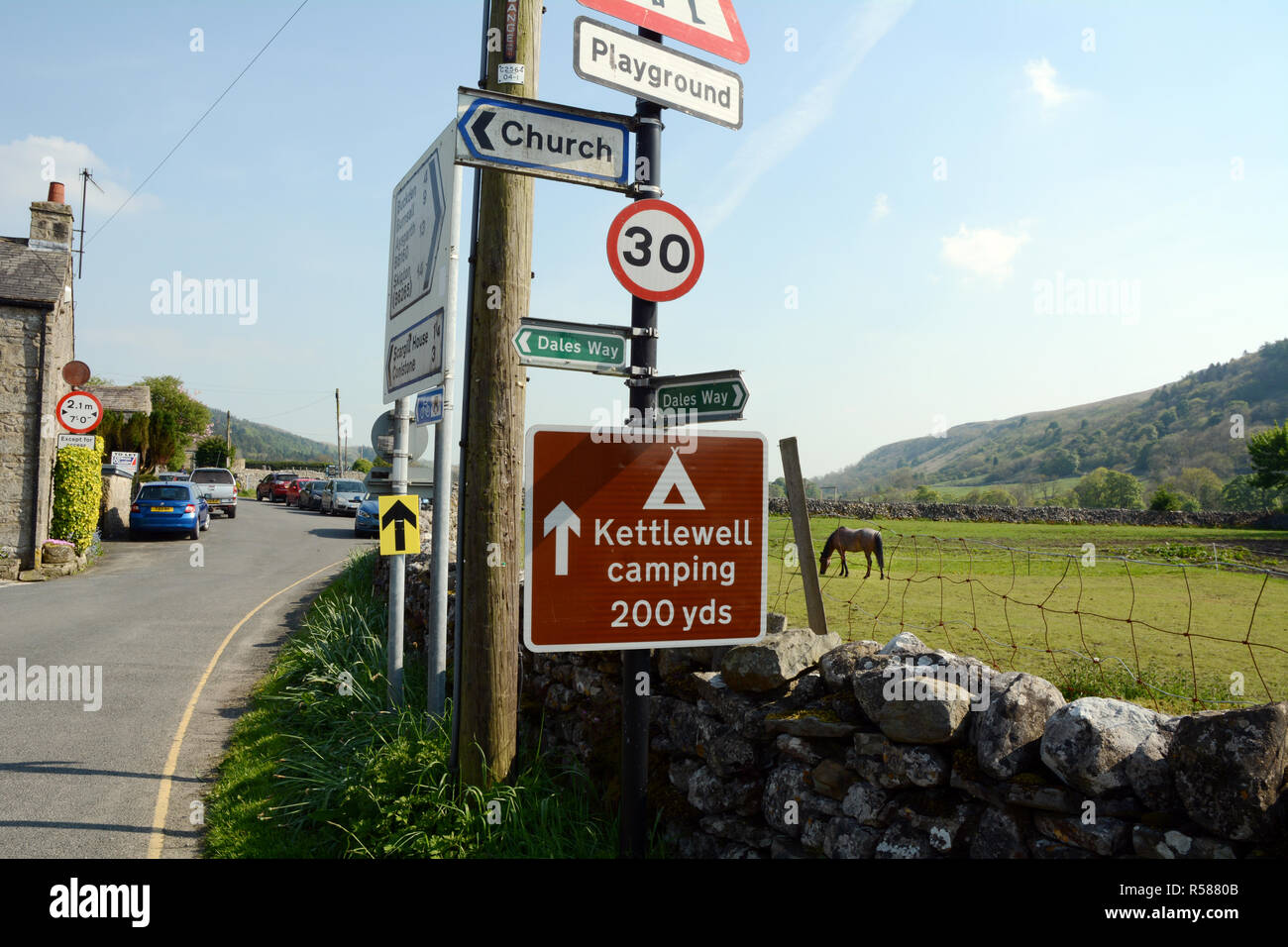 Street signs indicating a campsite and the Yorkshire Dales Way hiking ...