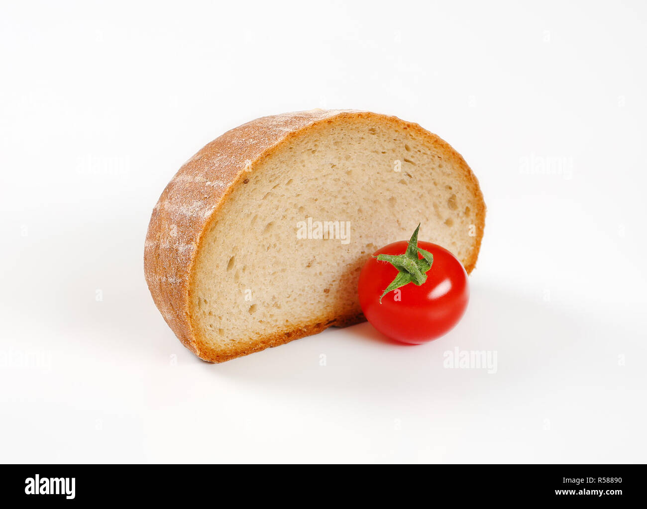 Half a loaf of continental bread and tomato Stock Photo - Alamy