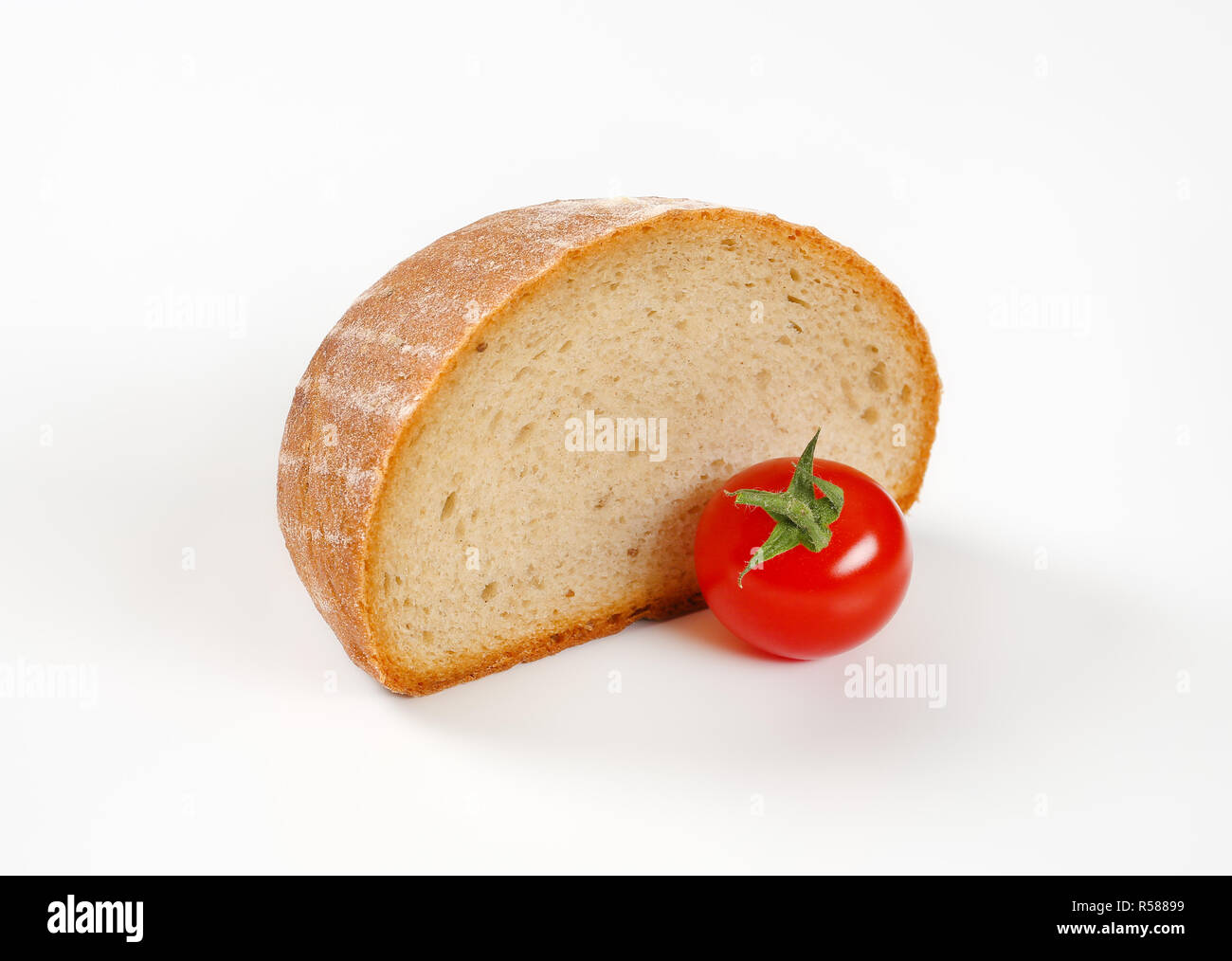 Half a loaf of continental bread and tomato Stock Photo - Alamy