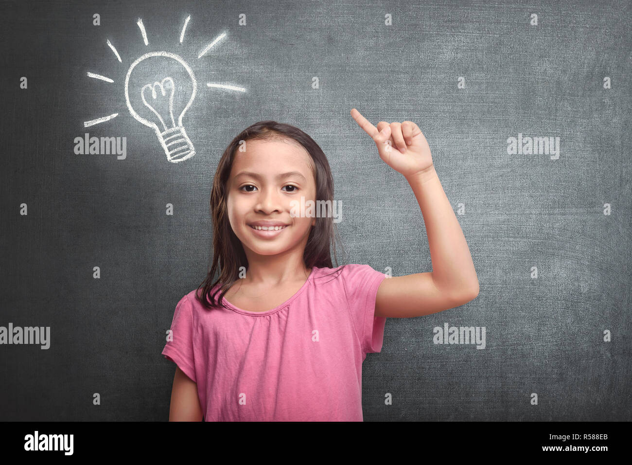 Cheerful asian kid with bright idea symbol above her head Stock Photo ...
