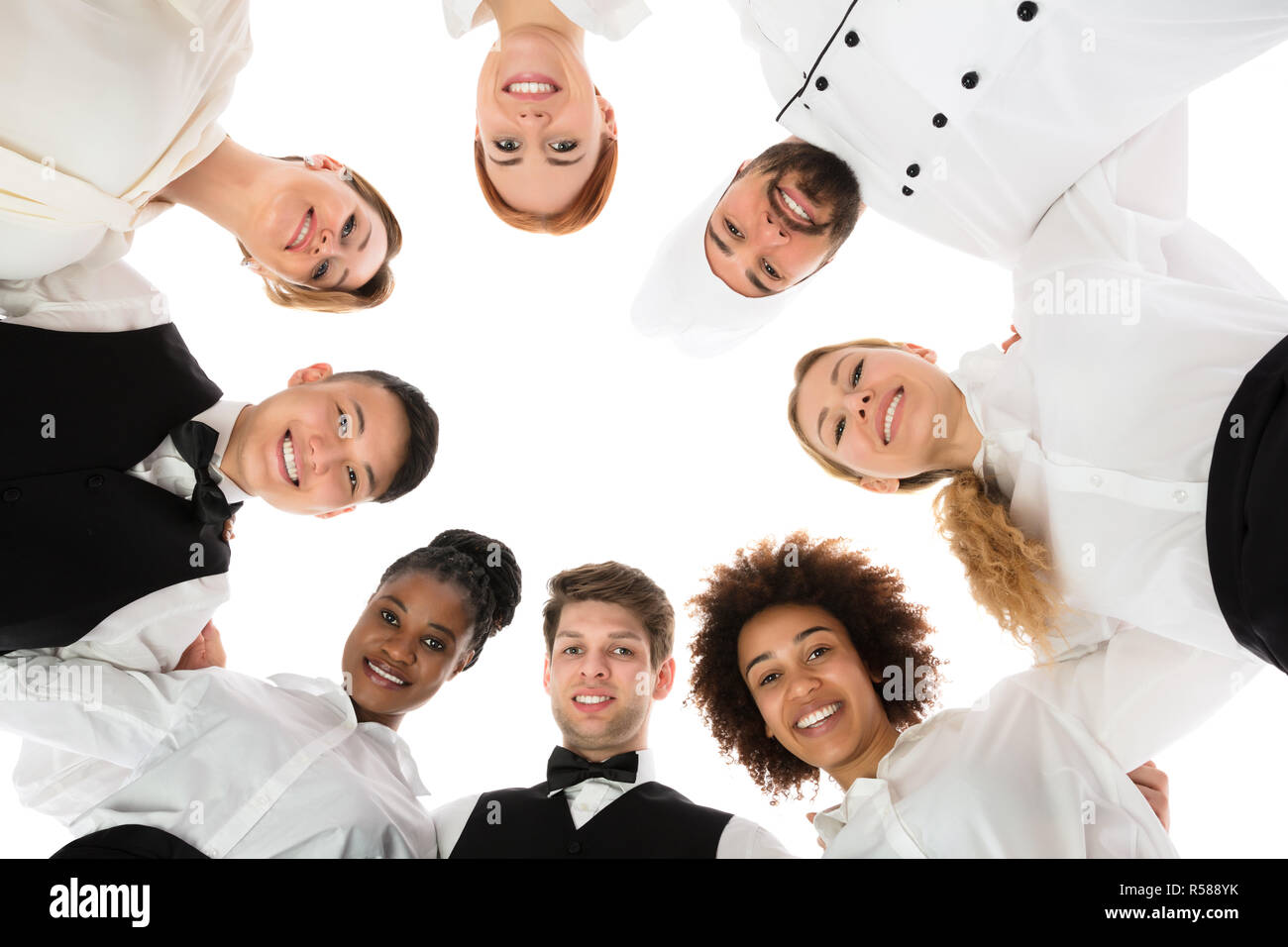 Happy Restaurant Staff Forming Huddle Stock Photo - Alamy