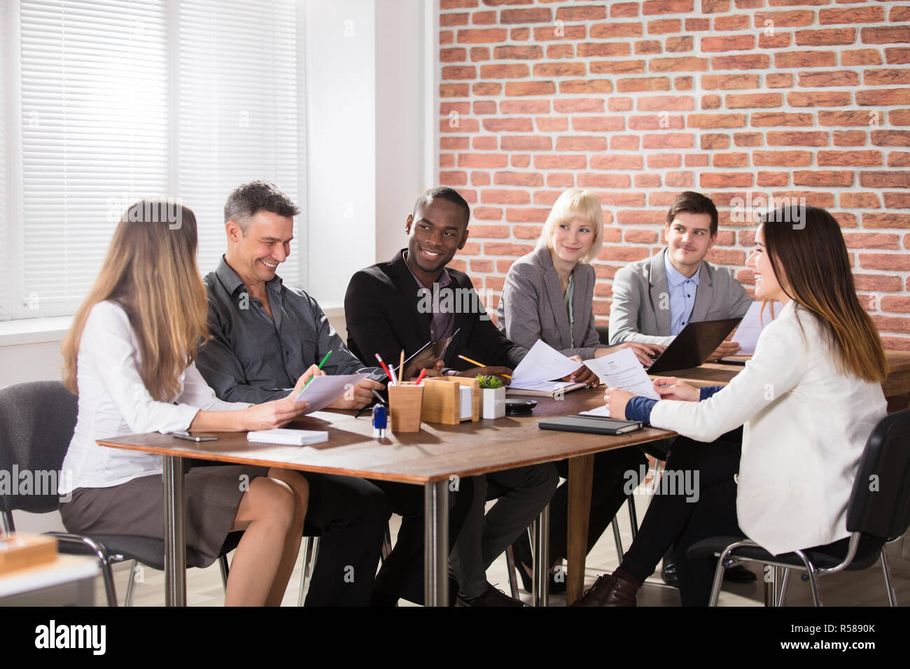 Business Team Discussing Successful Project Stock Photo - Alamy