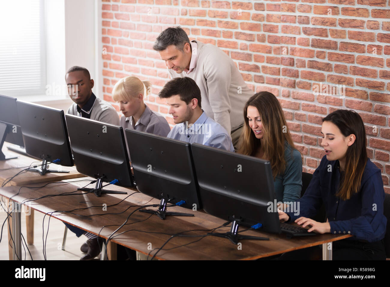Student With Teacher In Computer School Classroom Stock Photo - Alamy