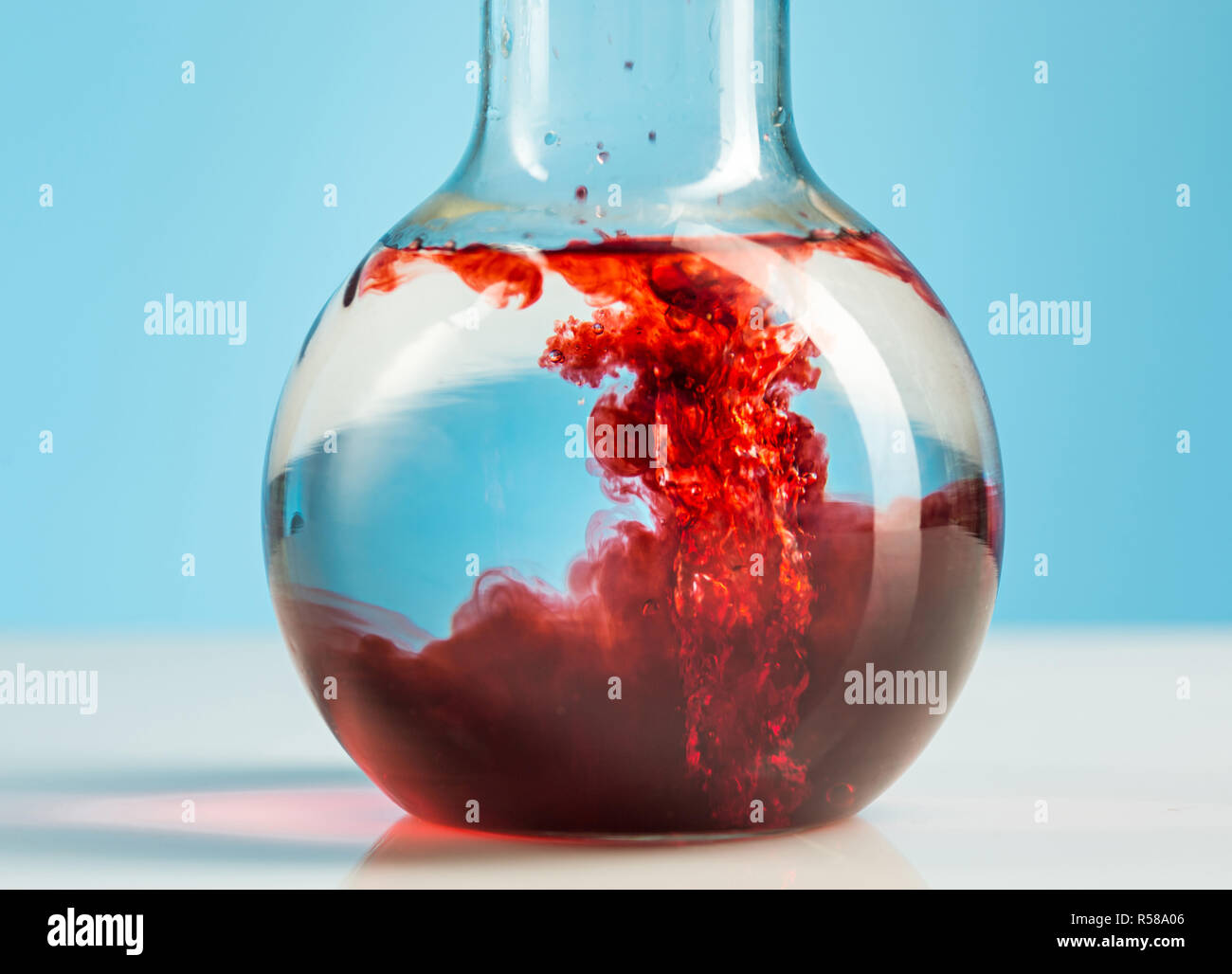 The laboratory glassware and red liquid inside on white Stock Photo - Alamy