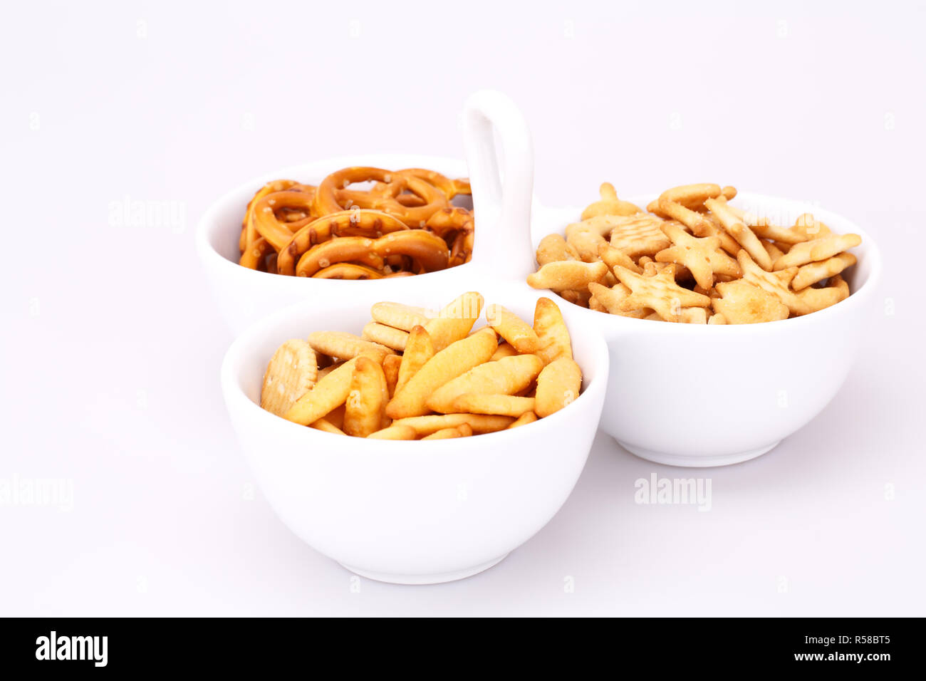 Different salted crackers in bowl isolated on white background Stock ...