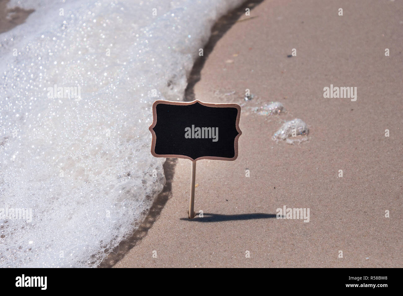 Empty wooden black sign on the beach Stock Photo - Alamy