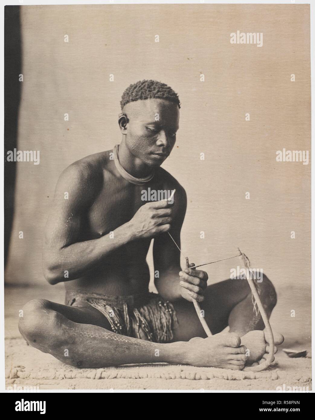 Making the pig arrow, Andaman Islands. The thick band which connects ...