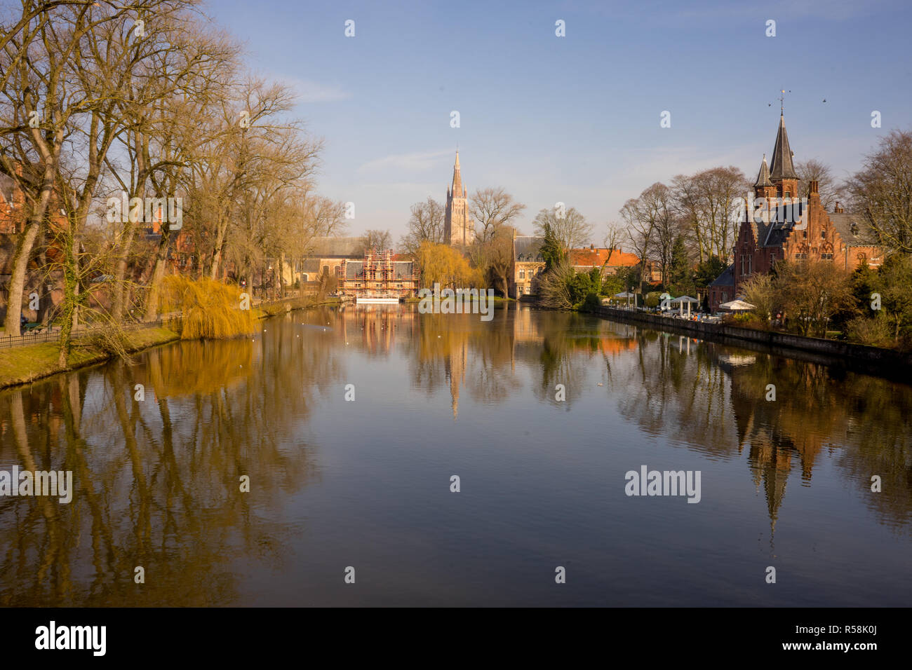 Belgium, Bruges, a bridge over a body of water surrounded by trees ...