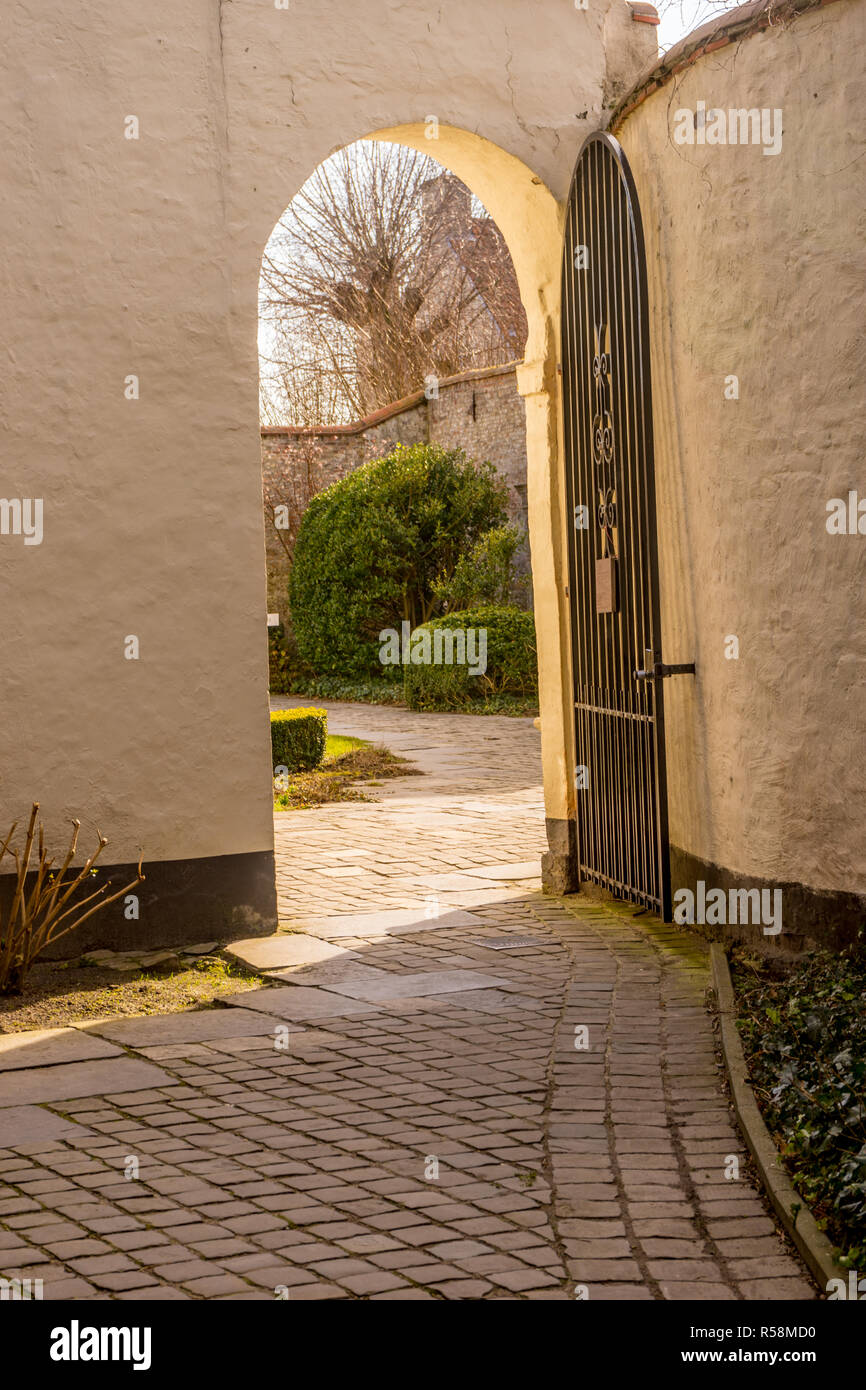 Belgium, Bruges, gate opening below an arch into a courtyard Stock ...