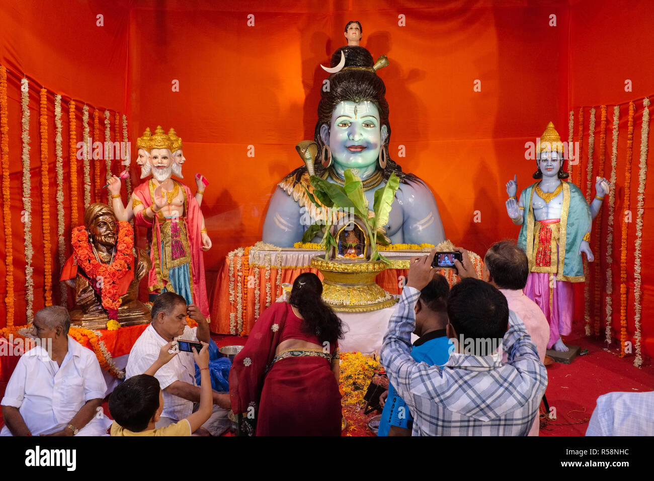 A makeshift shrine in Mumbai, India, featuring god Shiva at its center ...
