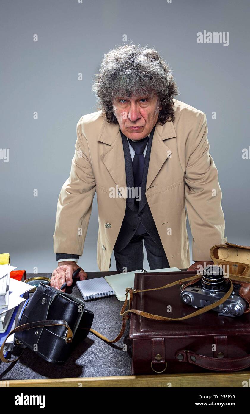 The senior man as detective or boss of mafia on gray studio background ...