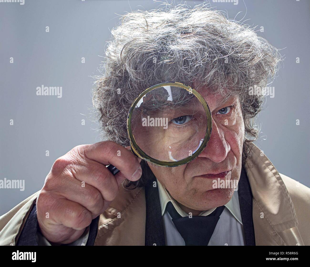 The senior man as detective or boss of mafia on gray studio background ...