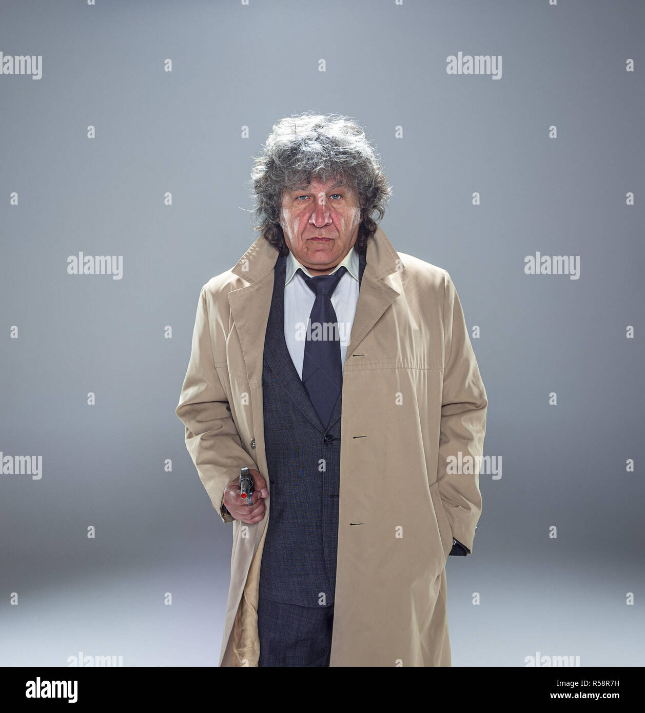Senior police agent with a gun on dark smoke background Stock Photo - Alamy