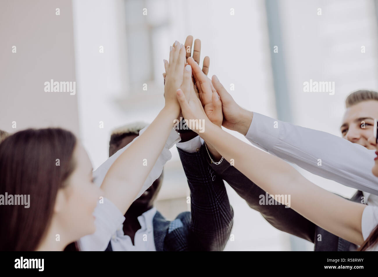 success and winning concept - happy business team giving high five in ...