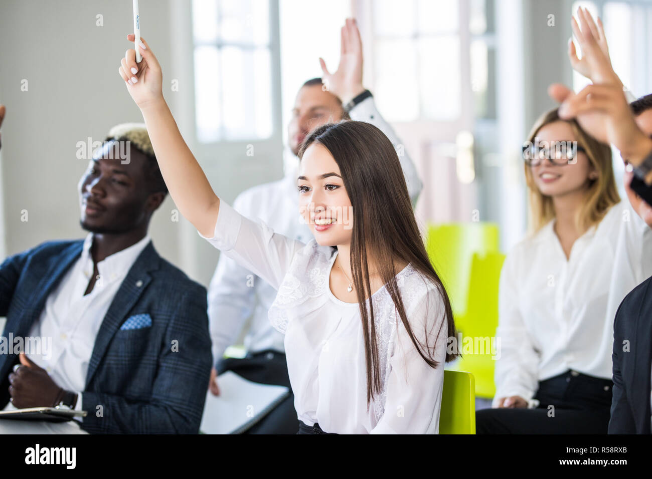 Business people raising hands hi-res stock photography and images - Alamy