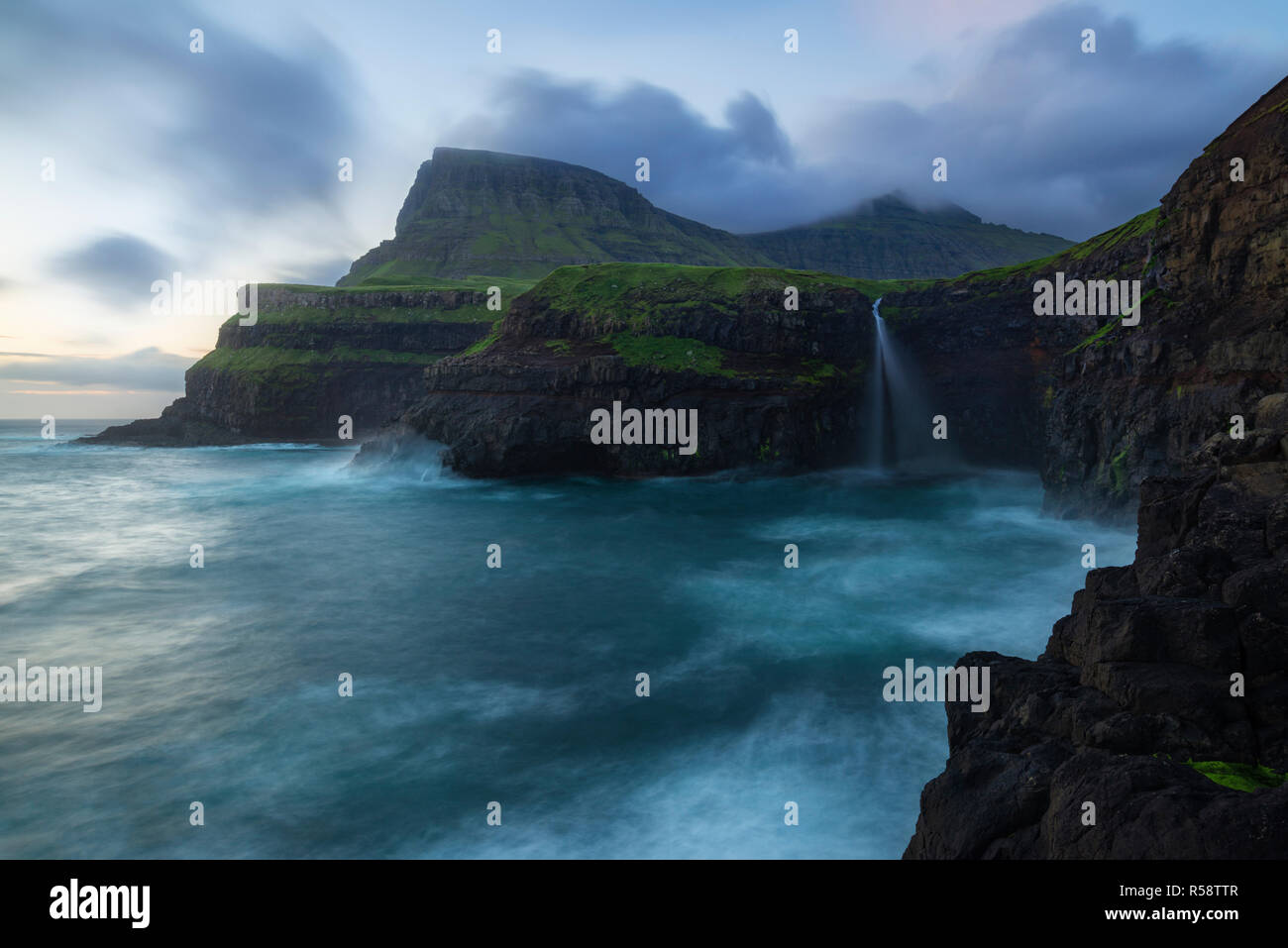 Storm winds and surf on the Faroe Islands with split waterfall ...