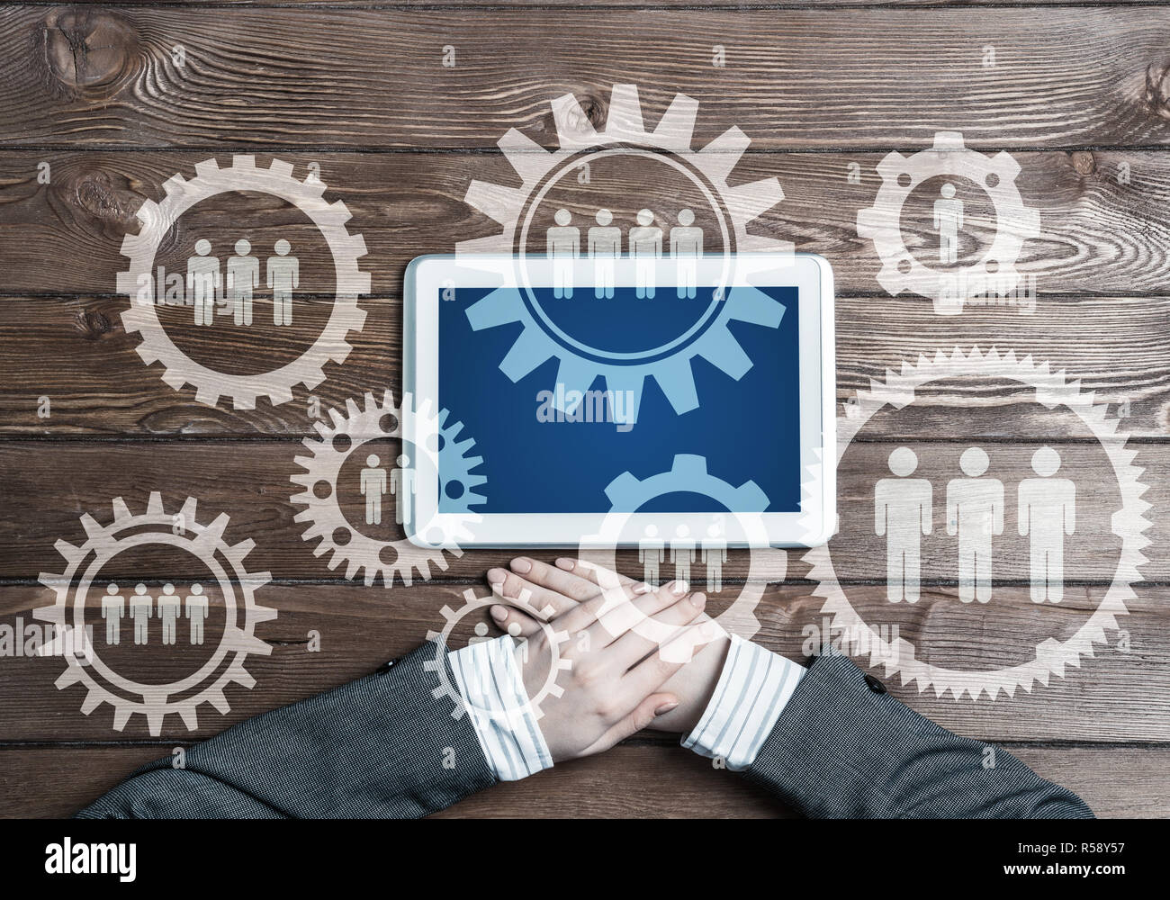 Concept of teamworking and connection with gears mechanism and tablet ...