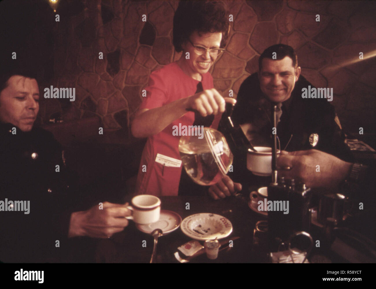 Waitress pours coffee for police officers in a cafe in Rifle, Colorado ...