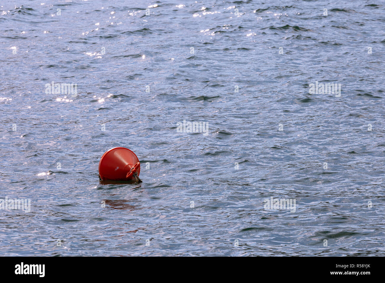 The red buoy floating in the middle of the sea Stock Photo - Alamy