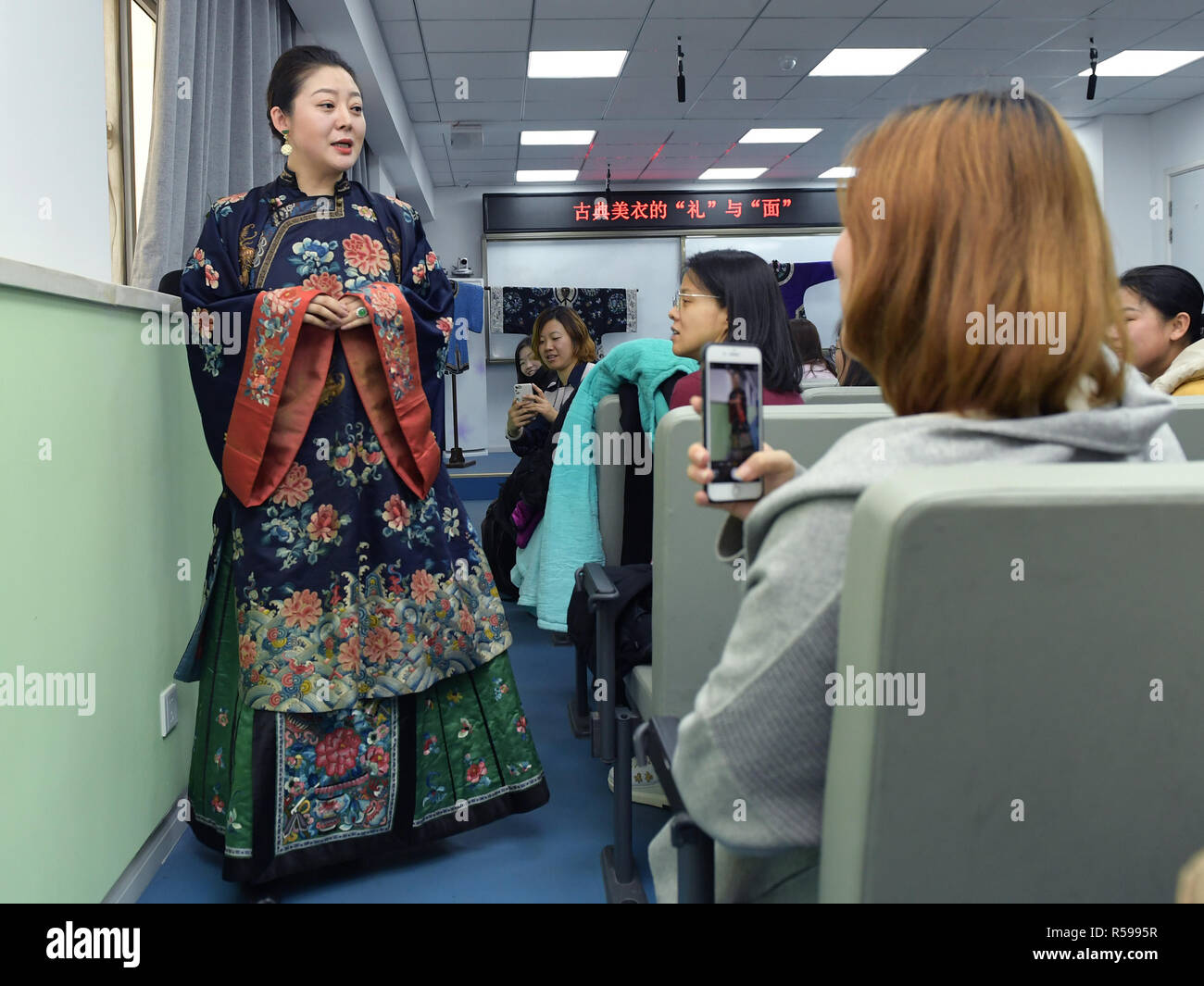 Beijing, China. 30th Nov, 2018. Designer Bi Hong (L) interacts with ...