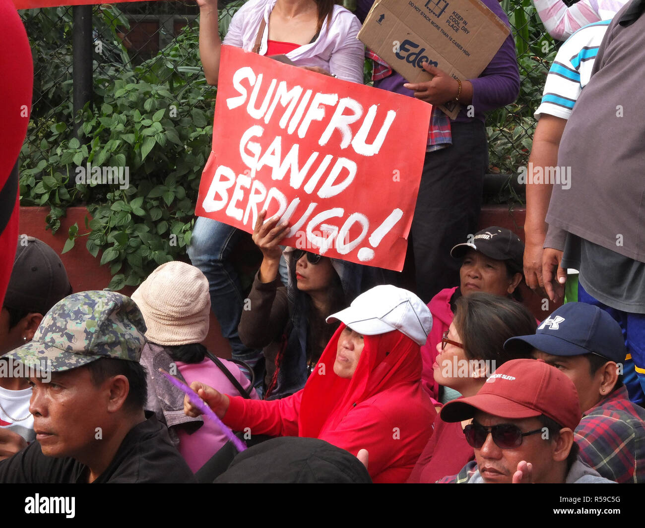 Manila, Philippines. 20th Feb, 2012. A protester seen holding a placard ...