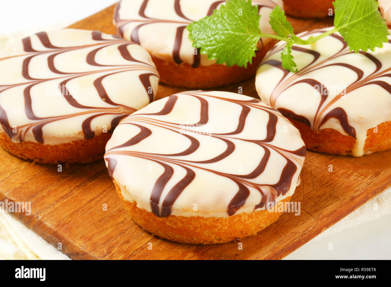 Chocolate-glazed mini cakes Stock Photo - Alamy