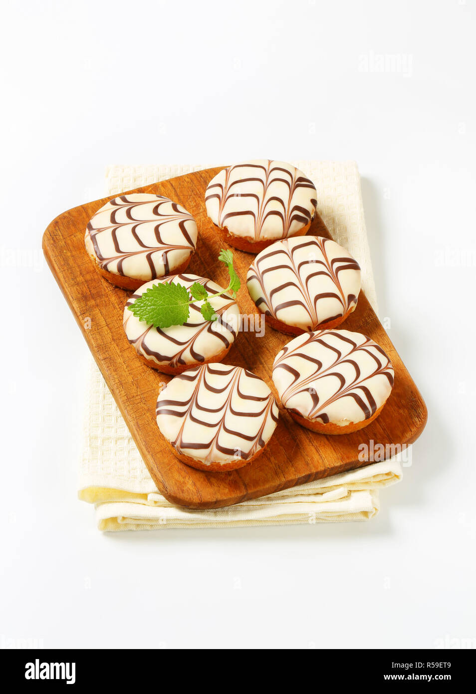 Chocolate-glazed mini cakes Stock Photo - Alamy