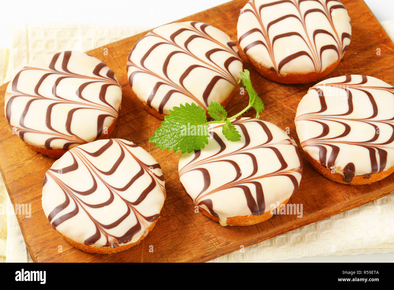 Chocolate-glazed mini cakes Stock Photo - Alamy