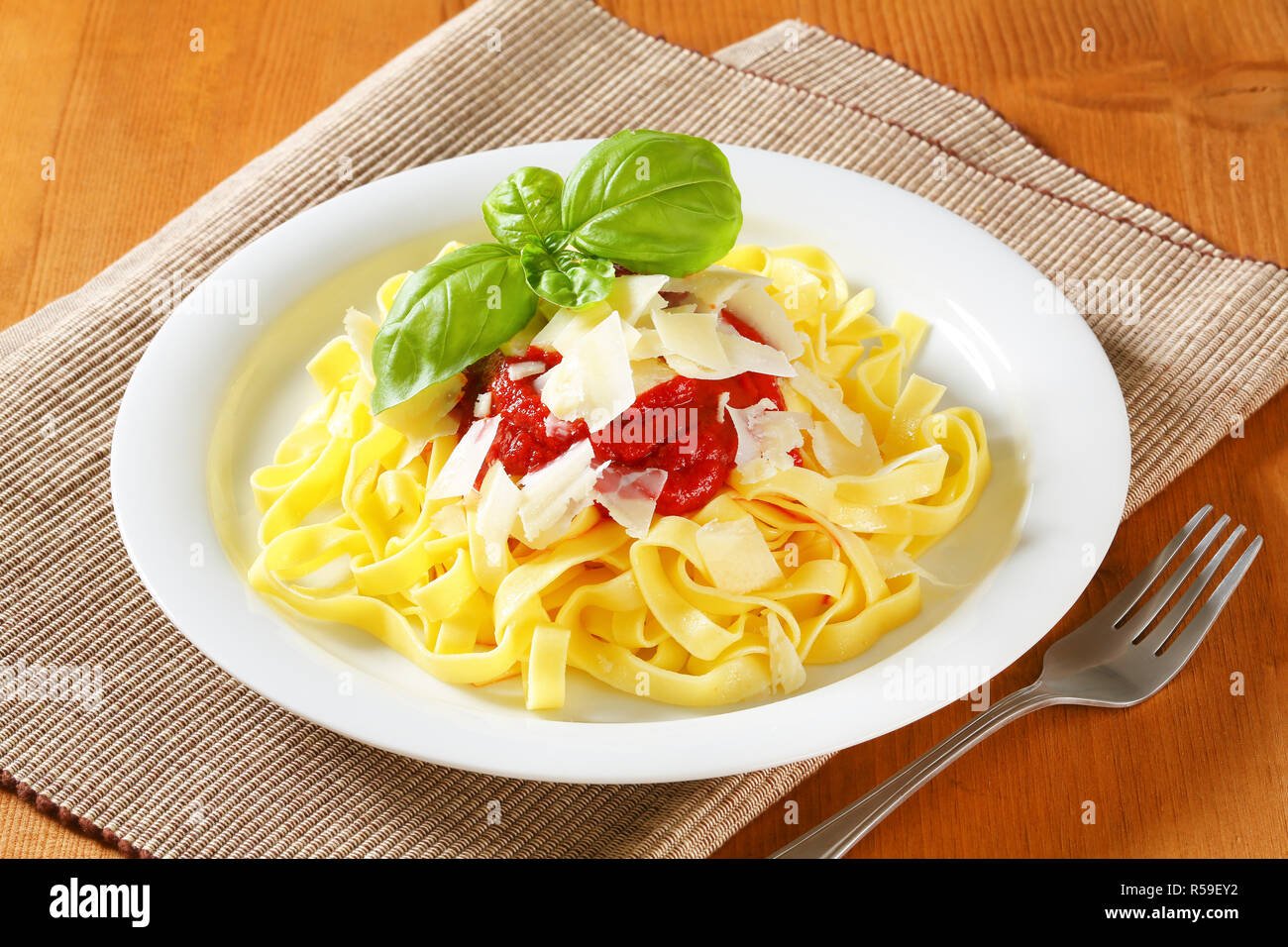 Ribbon pasta with tomato paste and Parmesan Stock Photo - Alamy